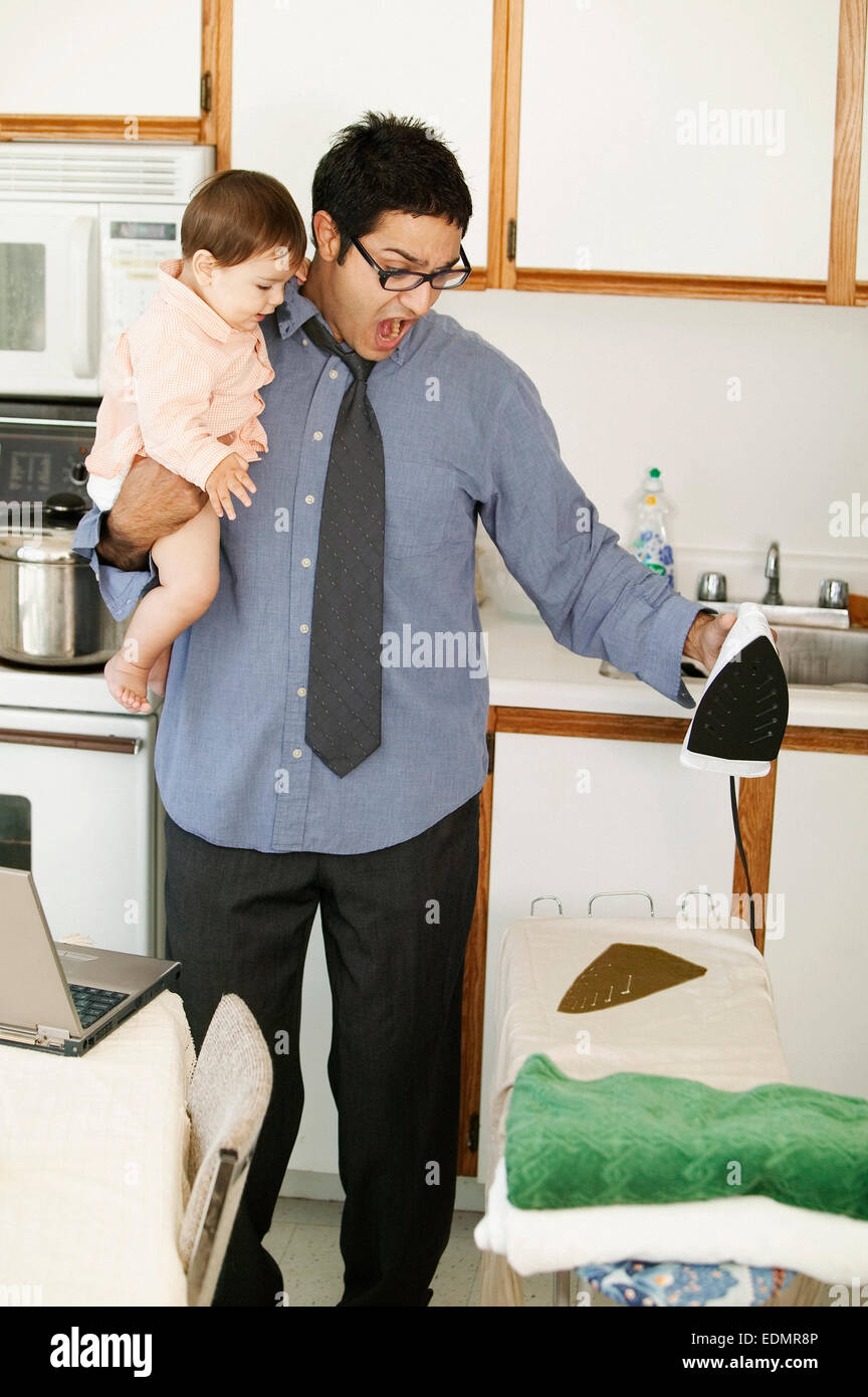 Father multitasking at home Stock Photo - Alamy