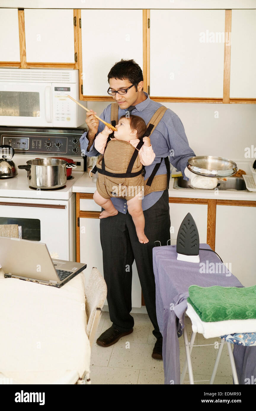 Father multitasking at home Stock Photo - Alamy