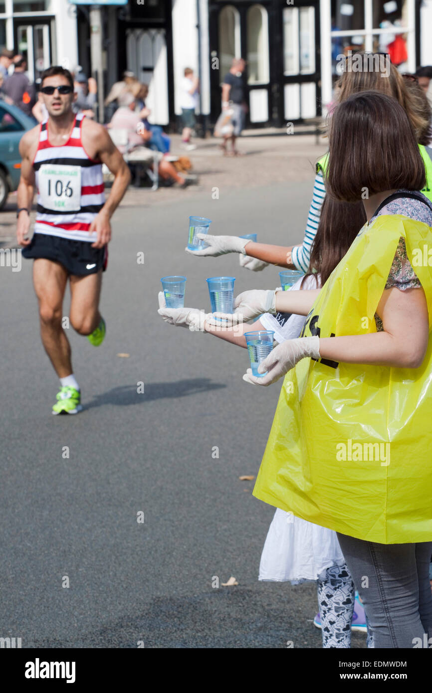 Water station at a 10k running road race Stock Photo - Alamy