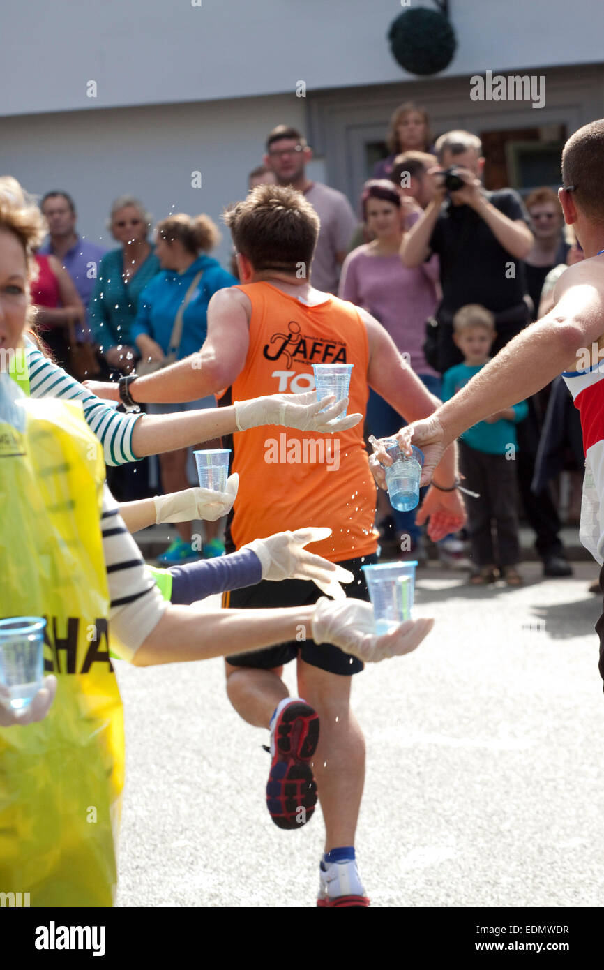 Water station at a 10k running road race Stock Photo - Alamy