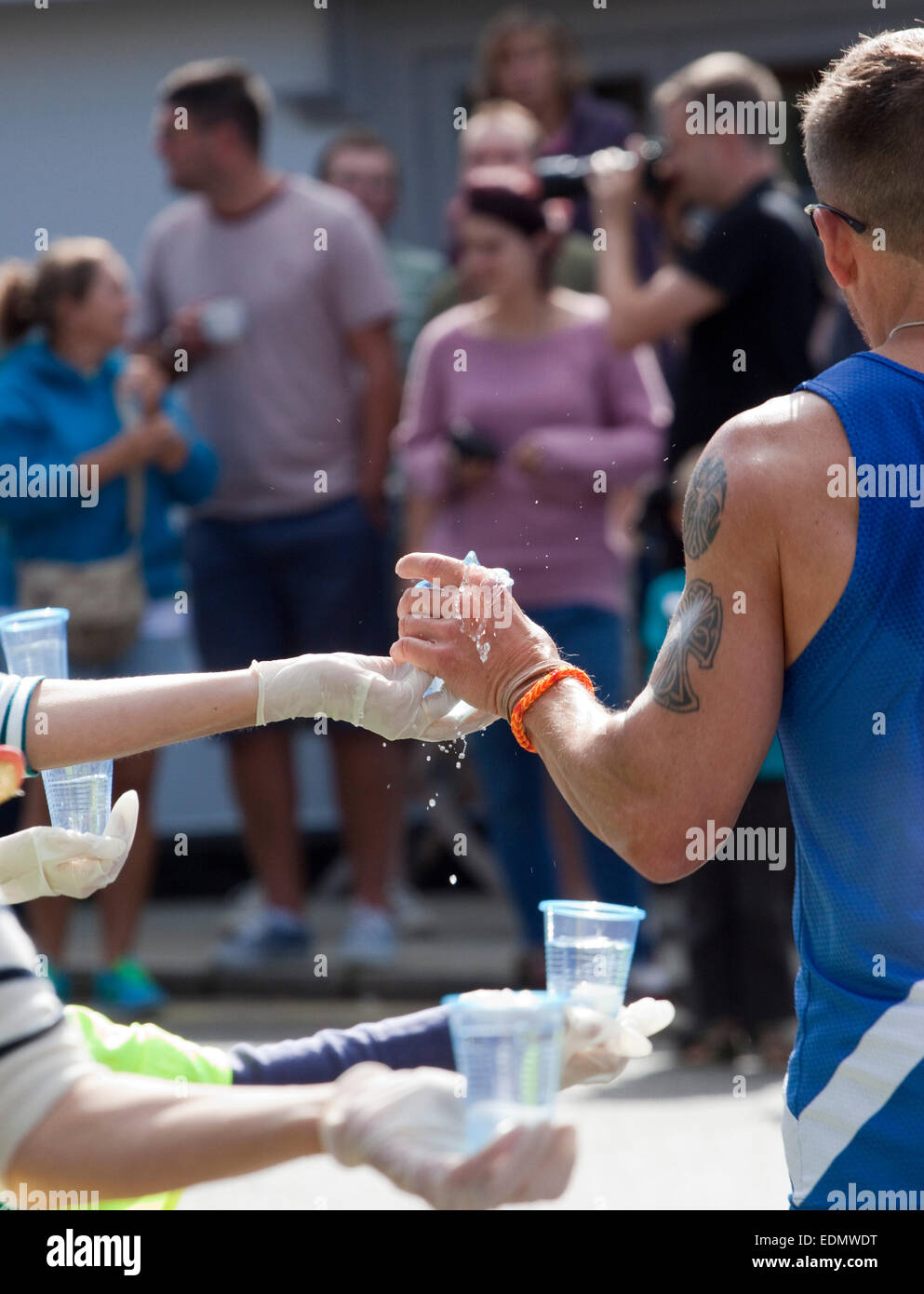 Water station at a 10k running road race Stock Photo - Alamy