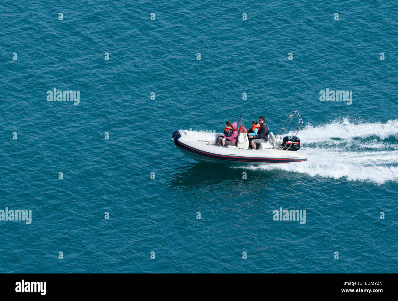 A family having fun in a speedboat on a lovely Spring day on the ...