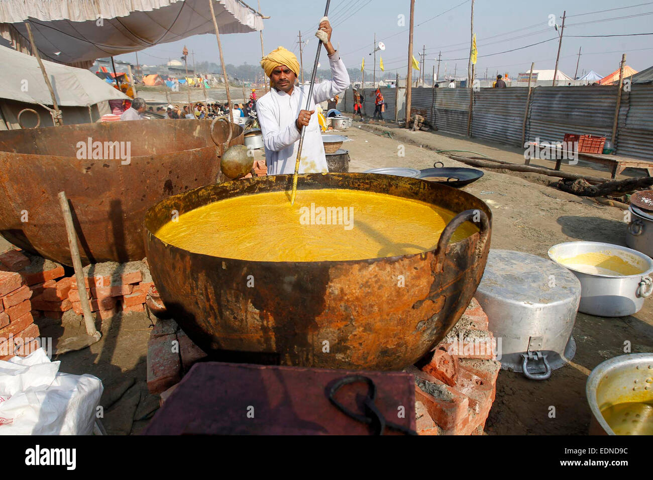A cook prepares food for langar at a camp during the one month "Magh ...