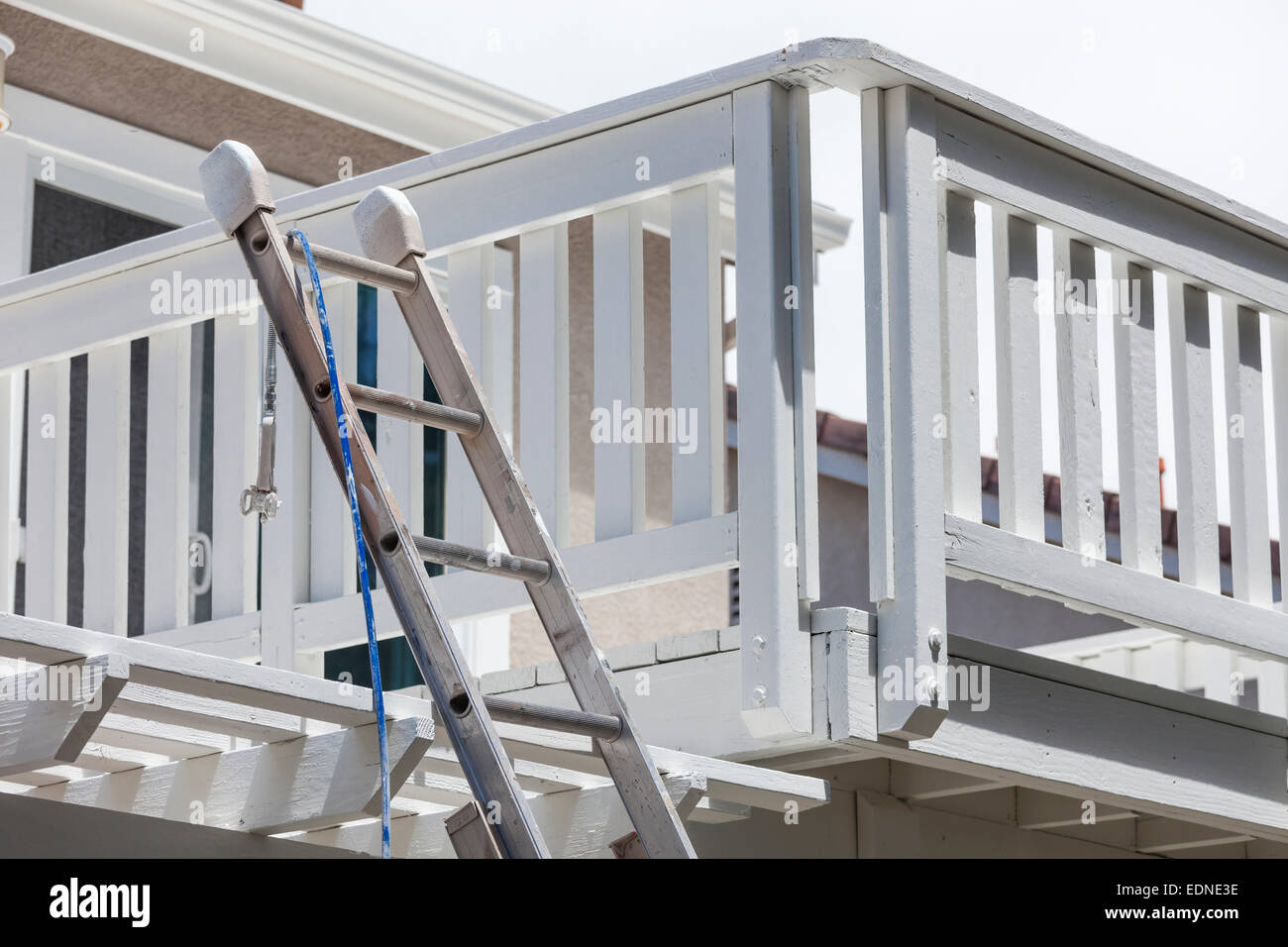 Construction Ladder and Painting Hose Leaning on White House Deck Stock ...