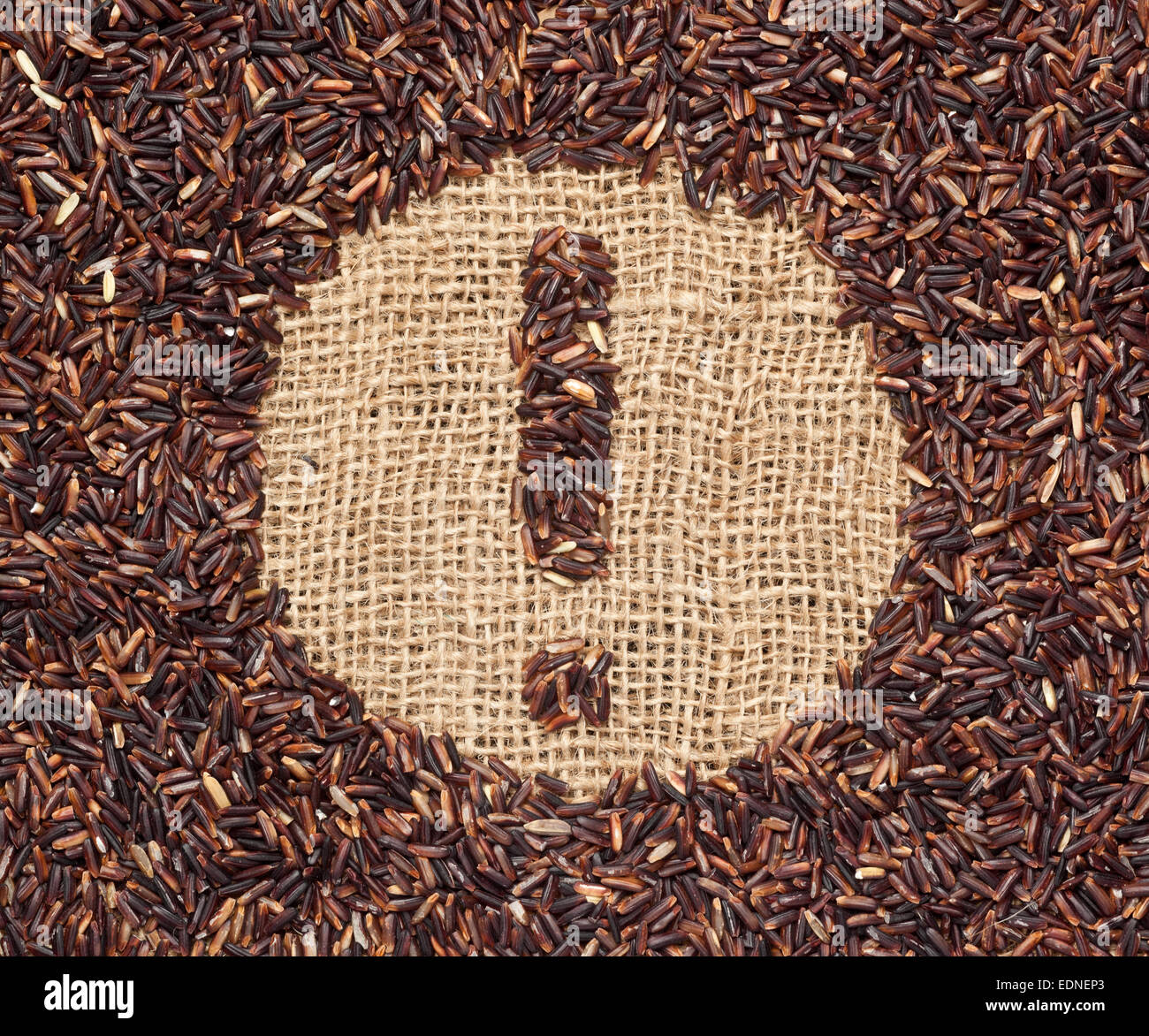 Red rice forming a exclaimation mark on burlap fabric Stock Photo - Alamy