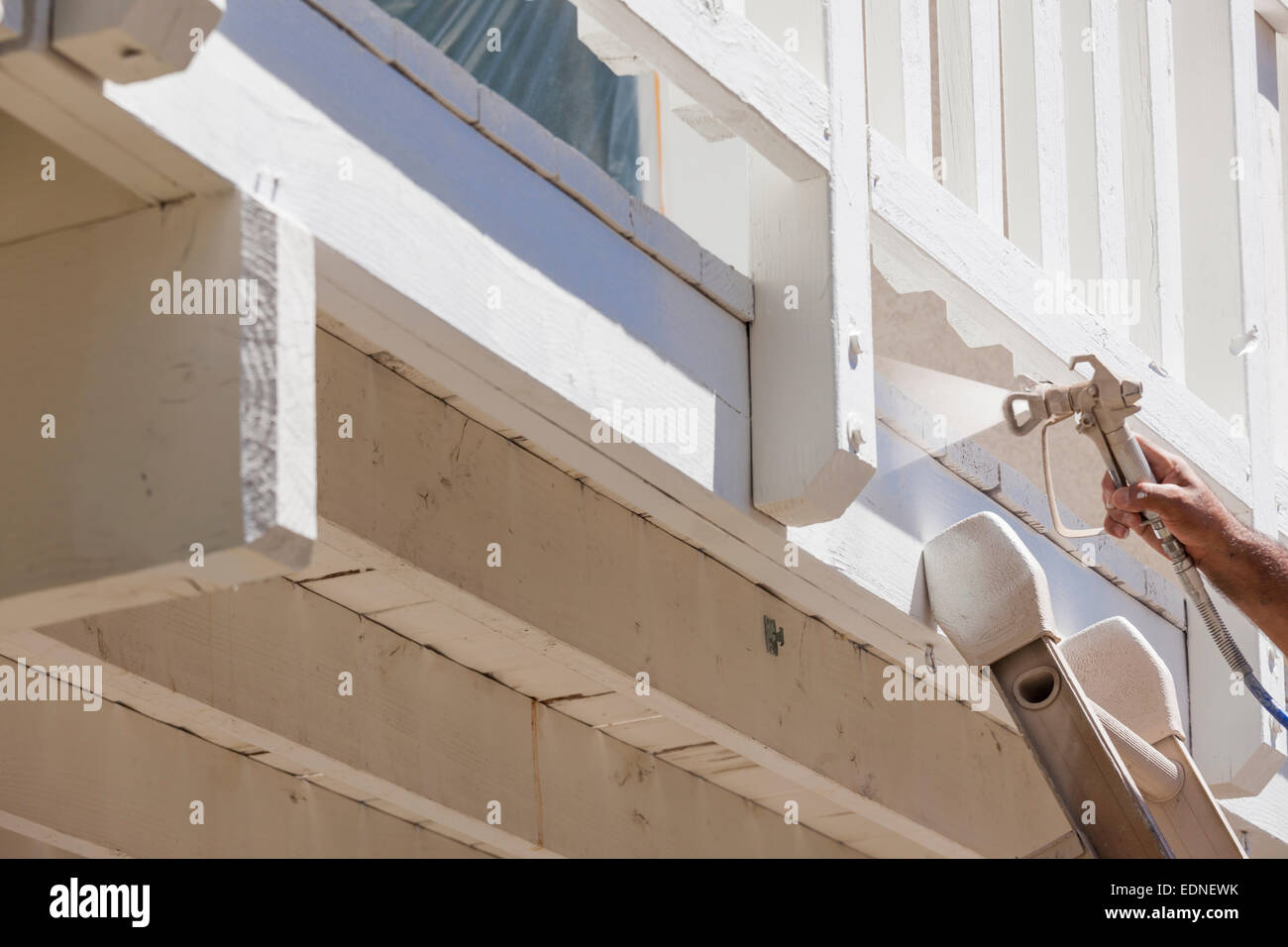 House Painter Wearing Facial Protection Spray Painting A Deck of A Home ...