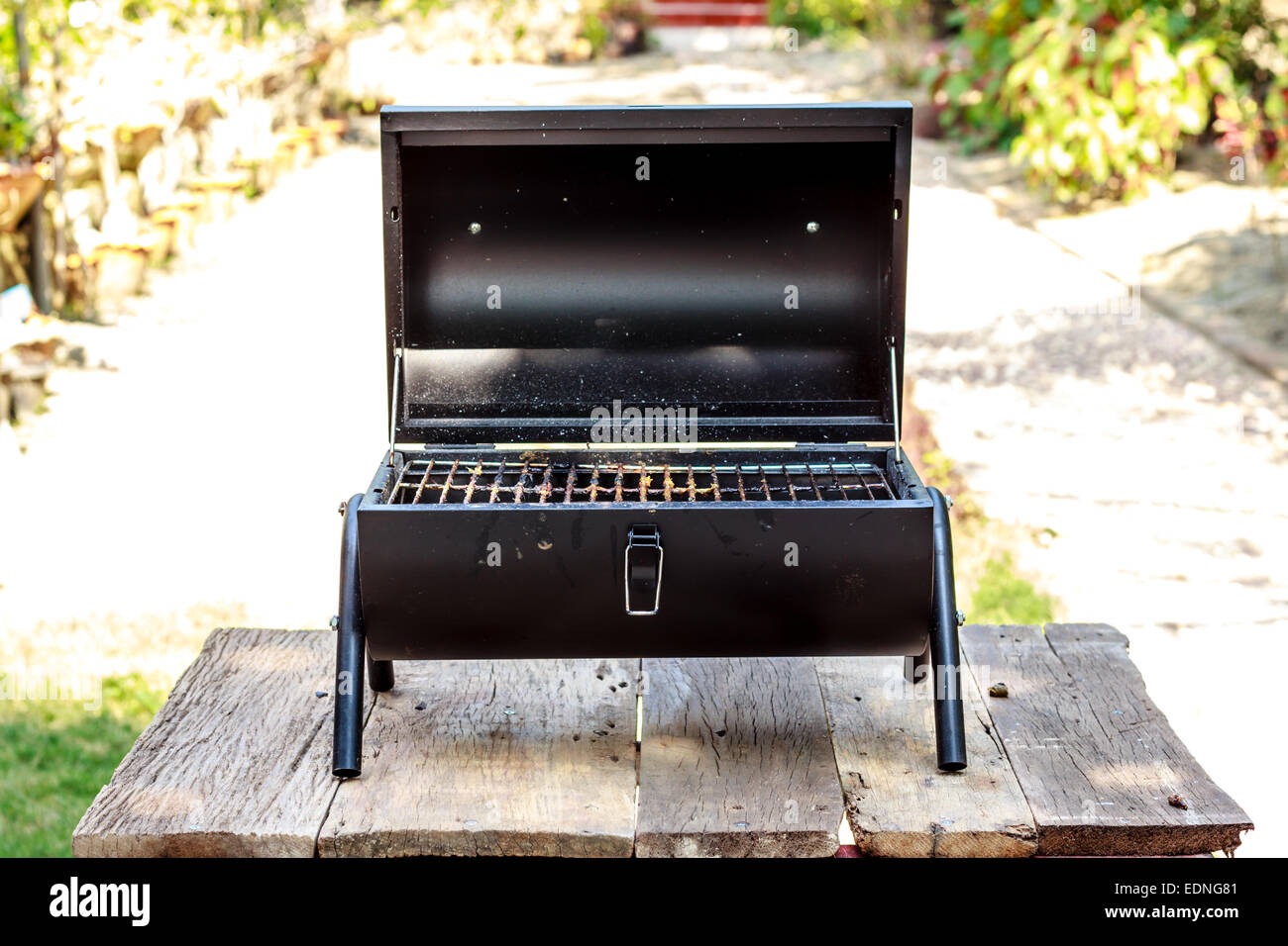 the portable barbecue on the wooden table Stock Photo - Alamy