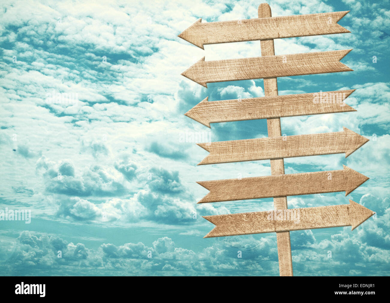 Blank brown wooden signpost against blue sky Stock Photo - Alamy