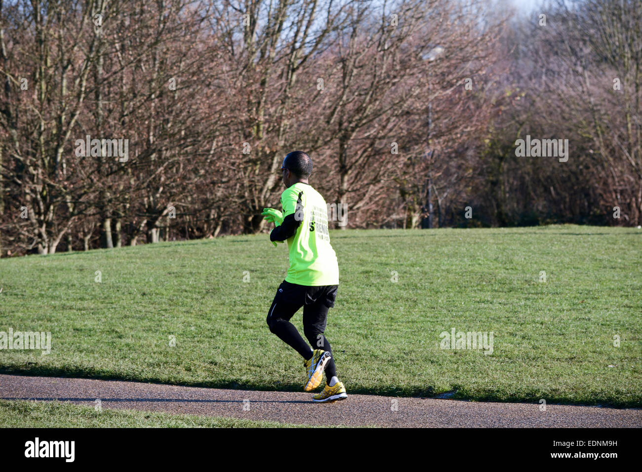 Man running around lake at Priory Marina, Bedford, Bedfordshire England ...