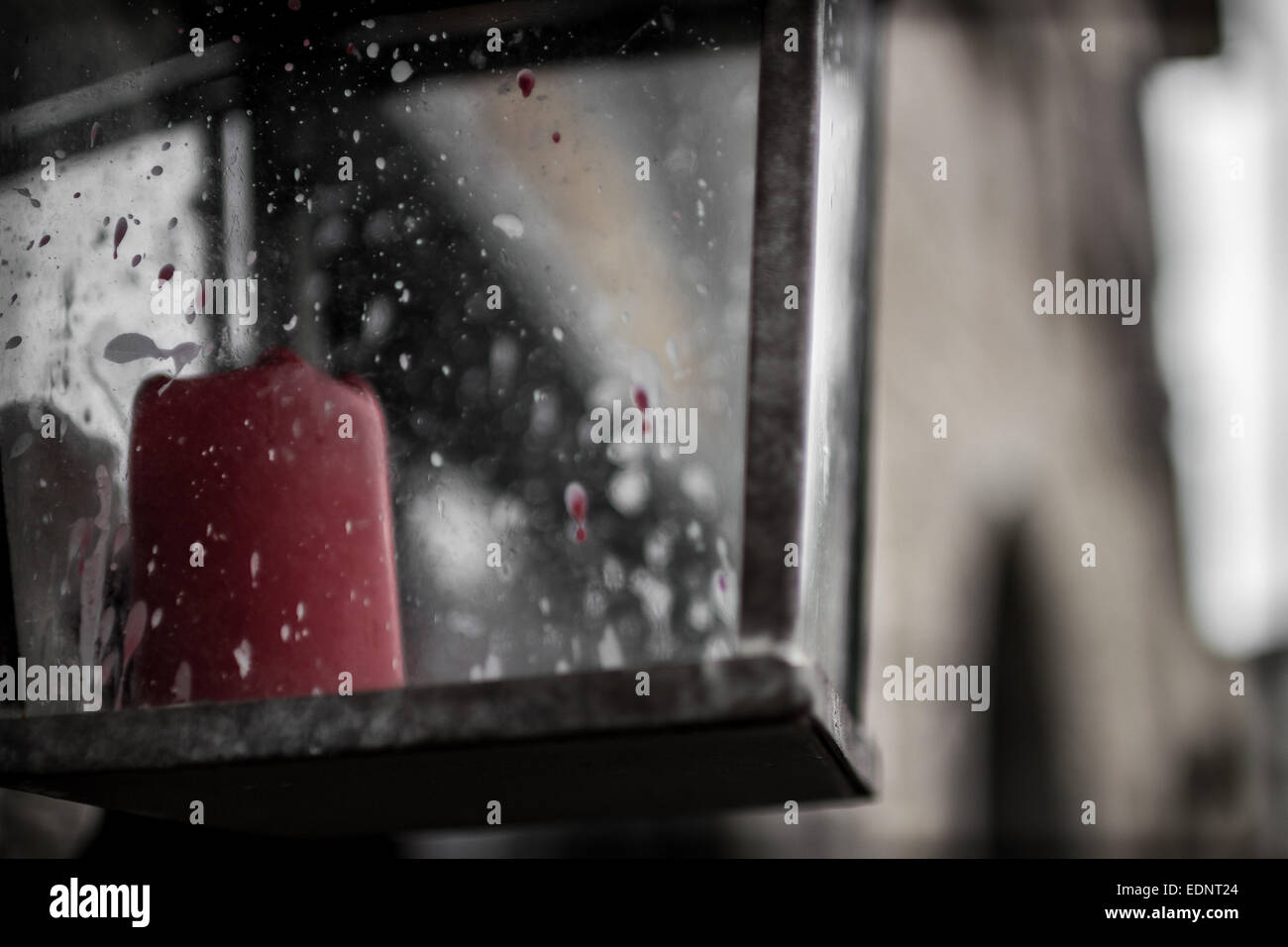 A lantern holds a red candle, turned off Stock Photo - Alamy