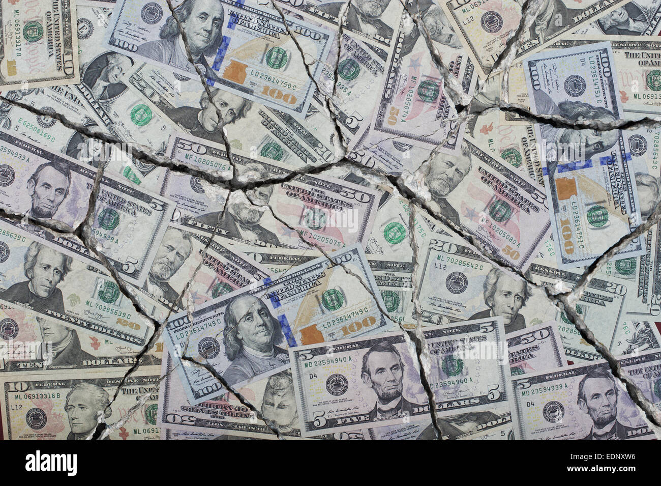 Cracked American dollar bills concept to represent an economic crisis ...