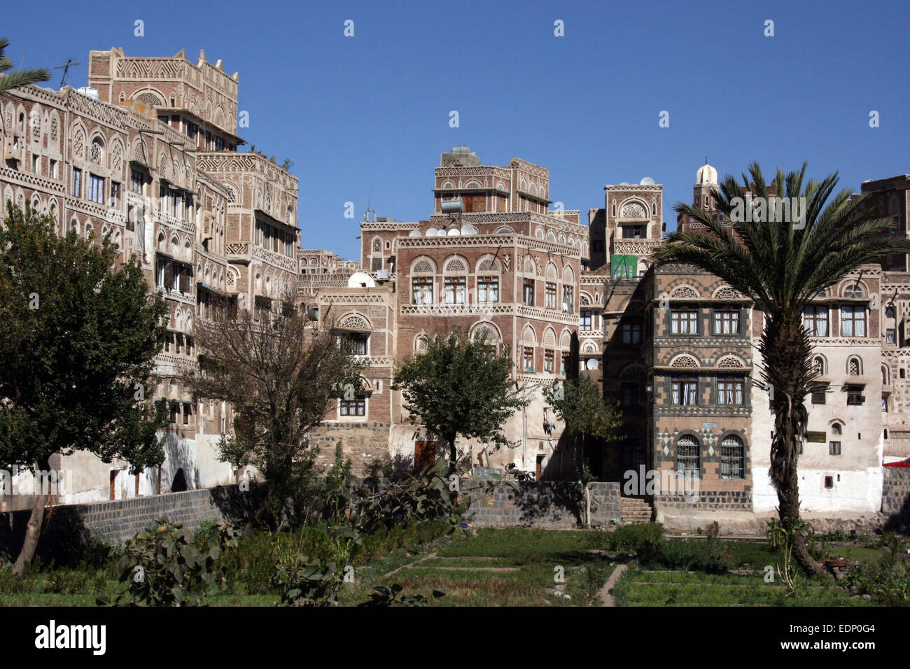 Traditional houses look on to a garden in the old town of Sanaa, Yemen ...