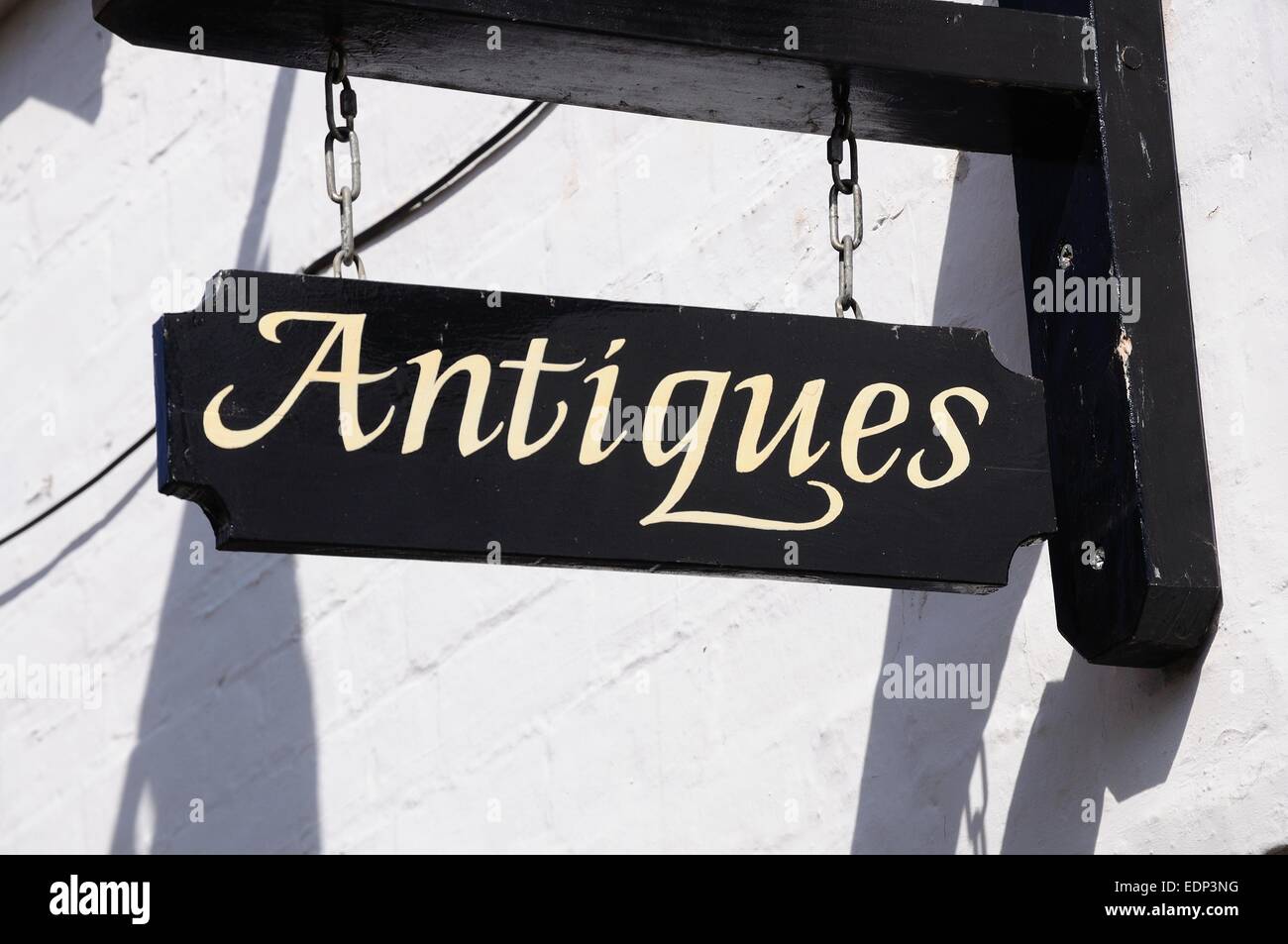 Old rustic antiques sign on a Tudor building, Tewkesbury ...