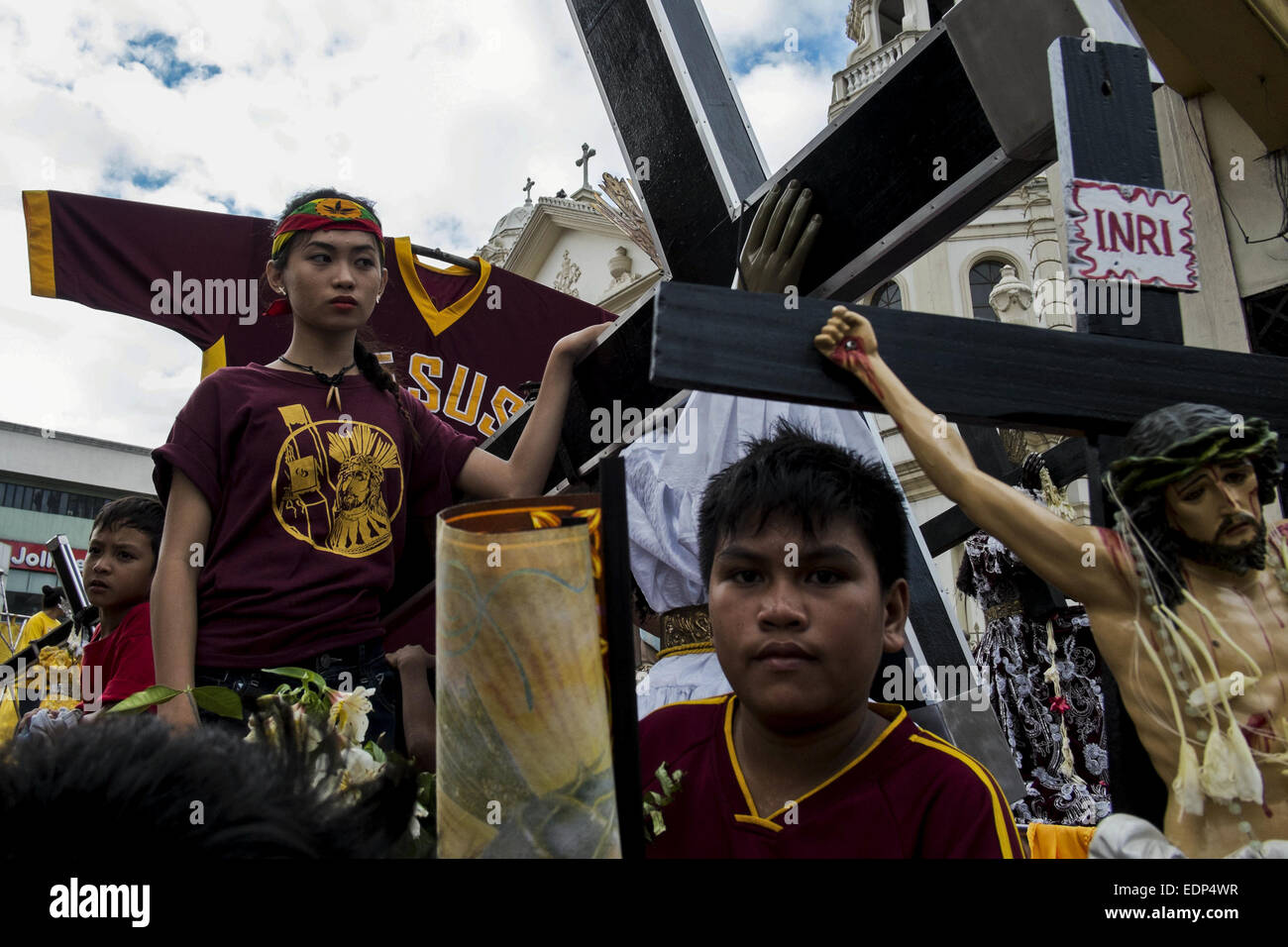 Devotees with their replicas of the Black Nazarene and other religiou ...