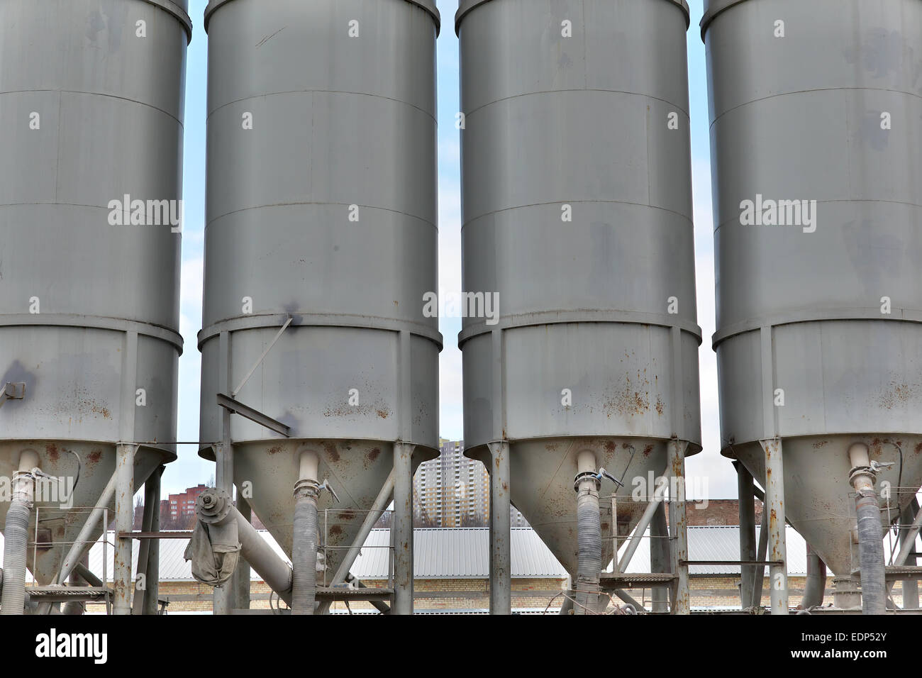 Cement factory silos closeup and production yard on the background ...