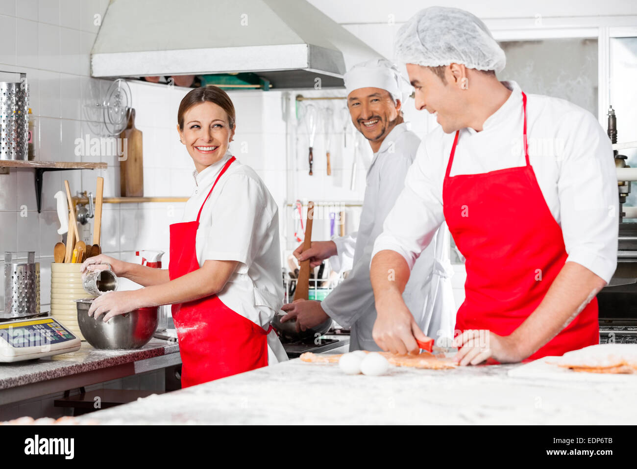 Happy Chefs Conversing In Commercial Kitchen Stock Photo - Alamy