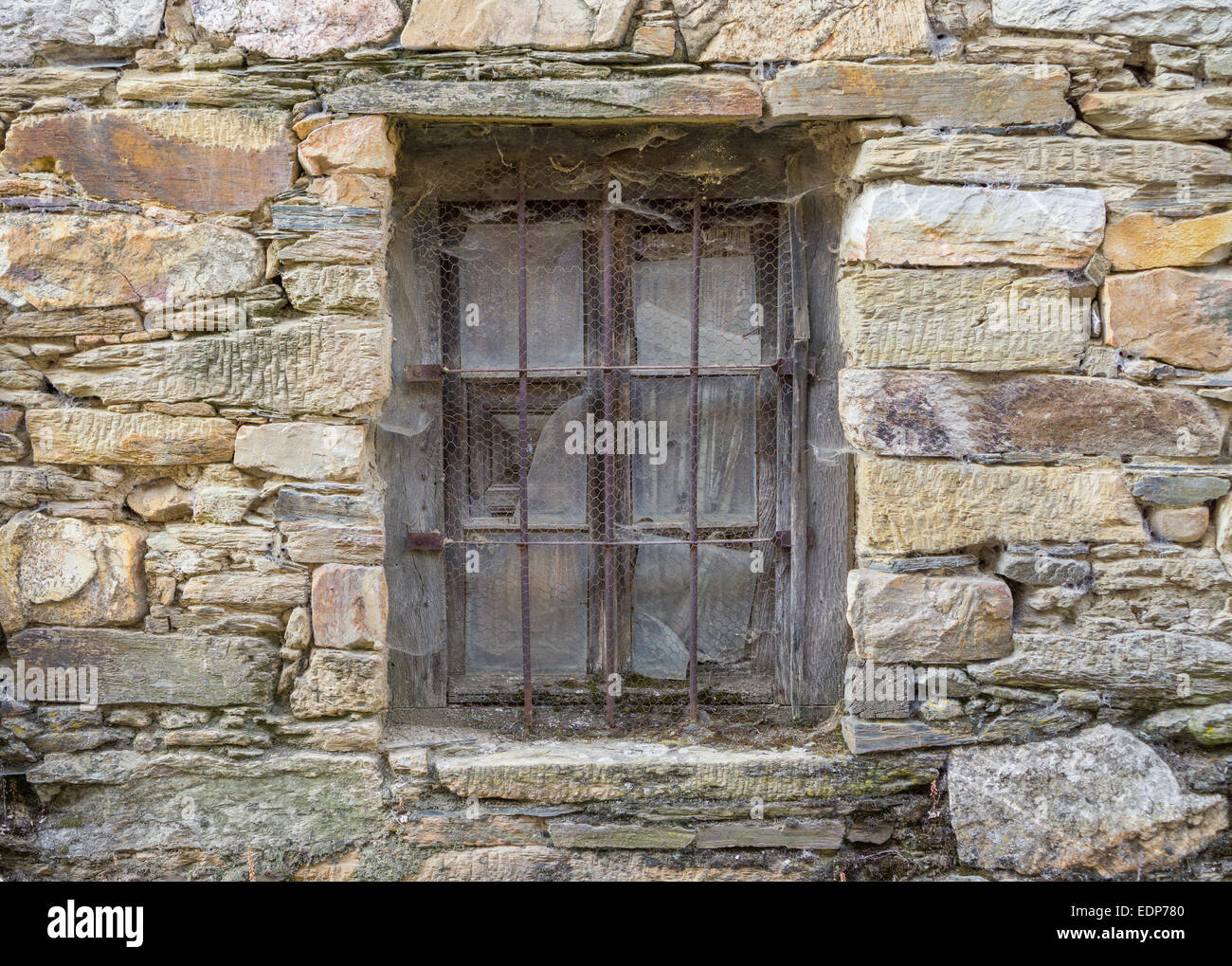 Old window with grille and stone wall Stock Photo - Alamy