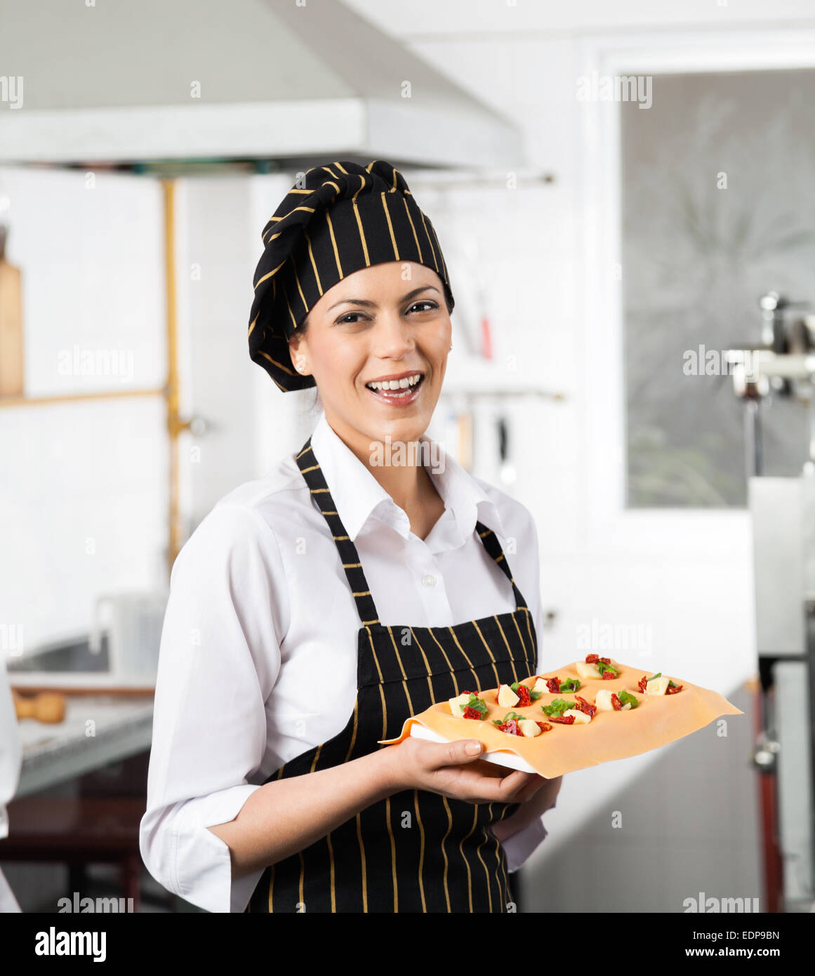 Happy Chef Holding Tray With Stuffed Pasta Sheet Stock Photo - Alamy