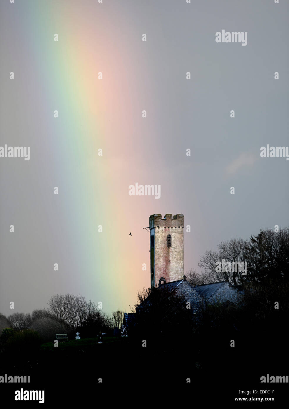 Rainbow over the church of St James in Manorbier South Wales UK Stock ...