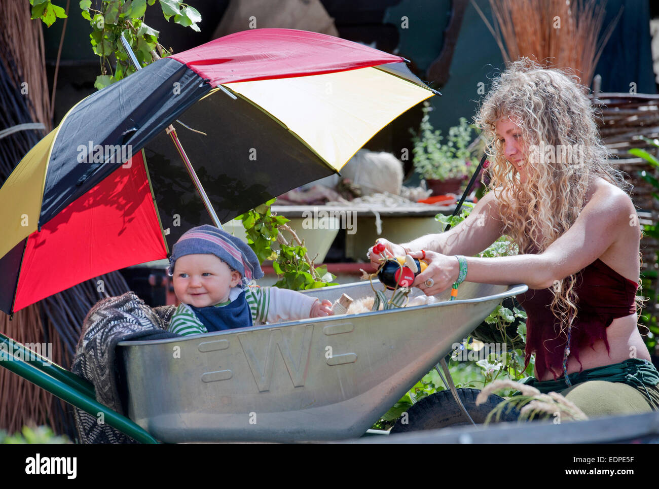Baby in a wheelbarrow in the Greencrafts area of Glastonbury June 2014 ...