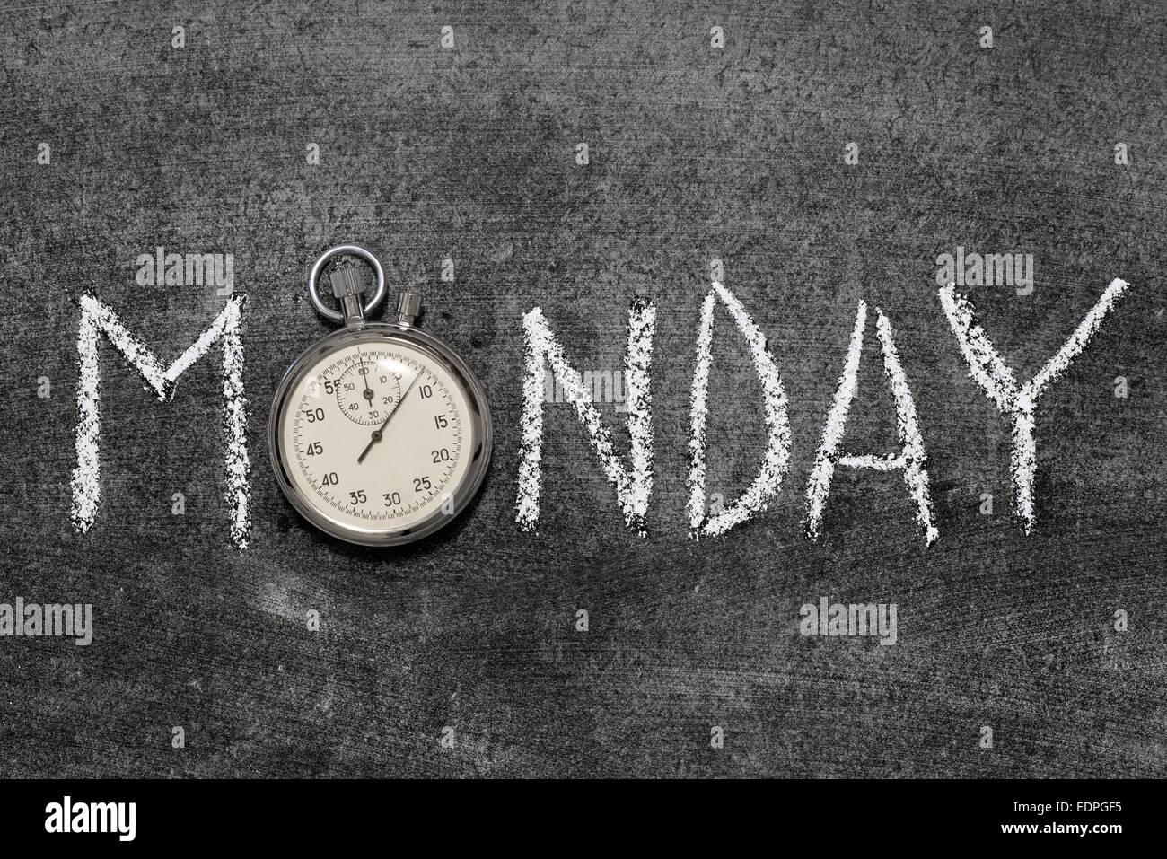 Monday word handwritten on chalkboard with vintage precise stopwatch ...