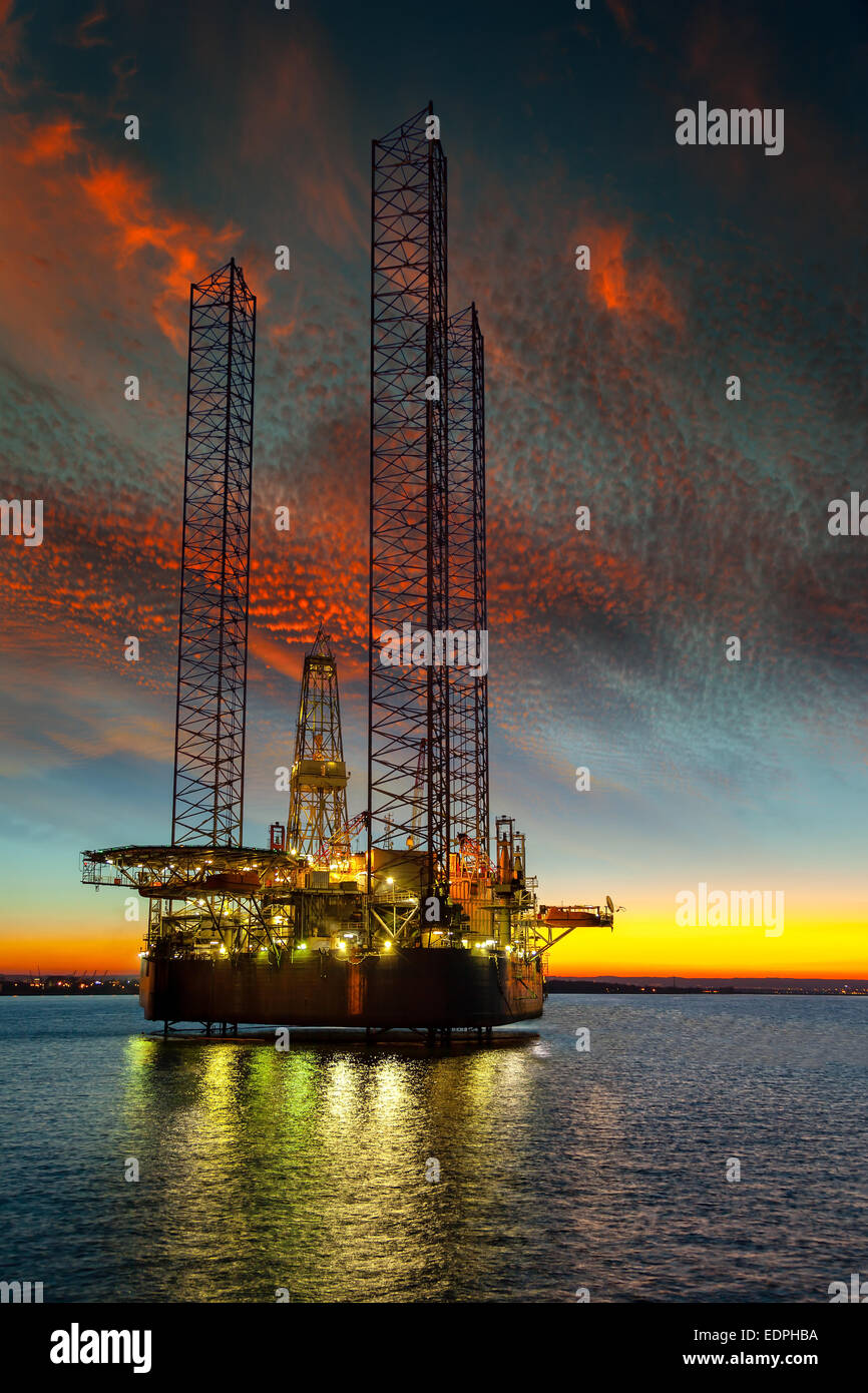 Oil drilling rig in sunset time Stock Photo - Alamy