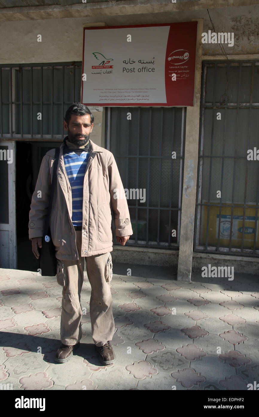 Kabul, Afghanistan. 14th Dec, 2014. Postman Shah Mohammad stands in ...