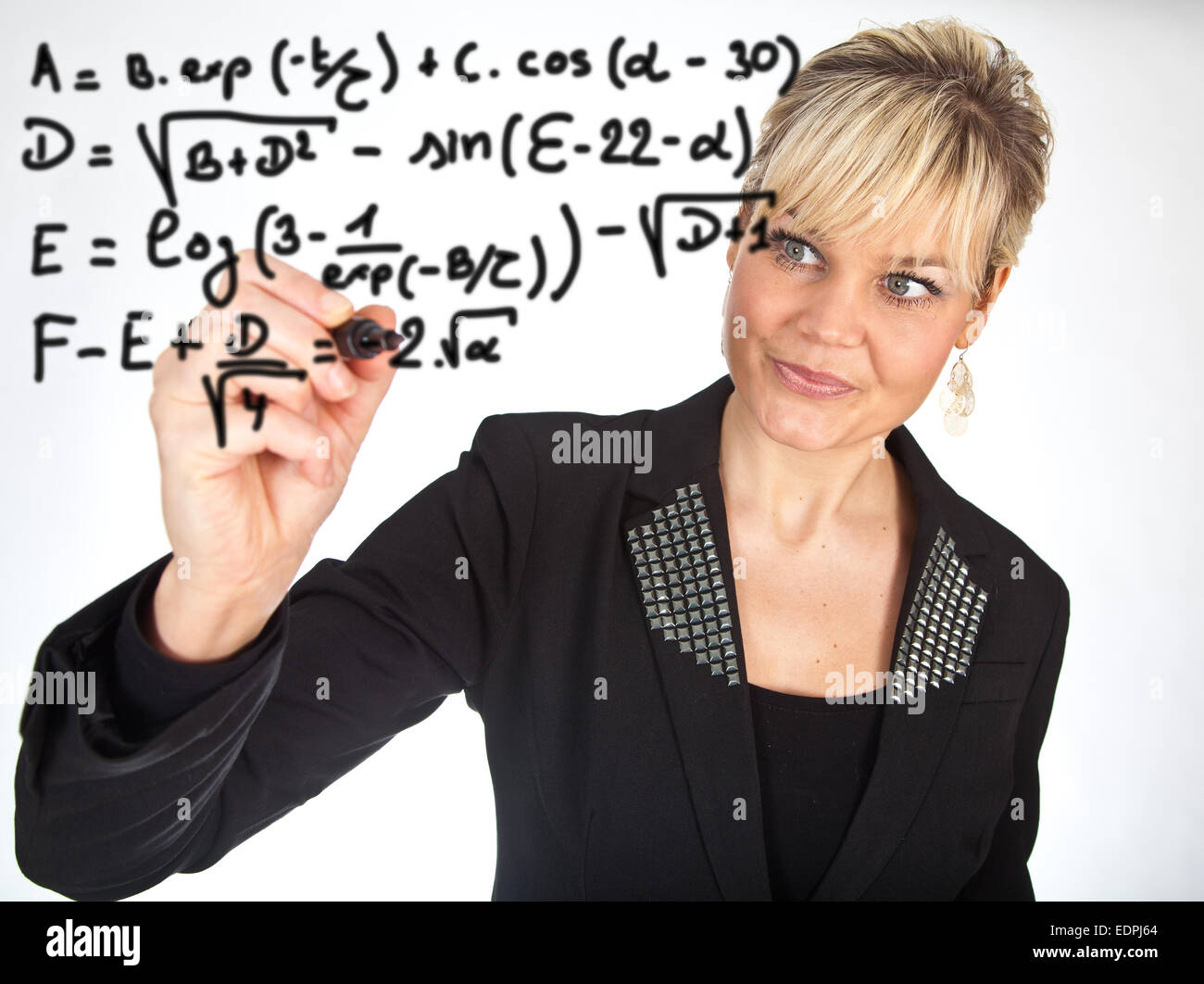 Studio portrait of a cute blond girl writing maths on a transparent ...