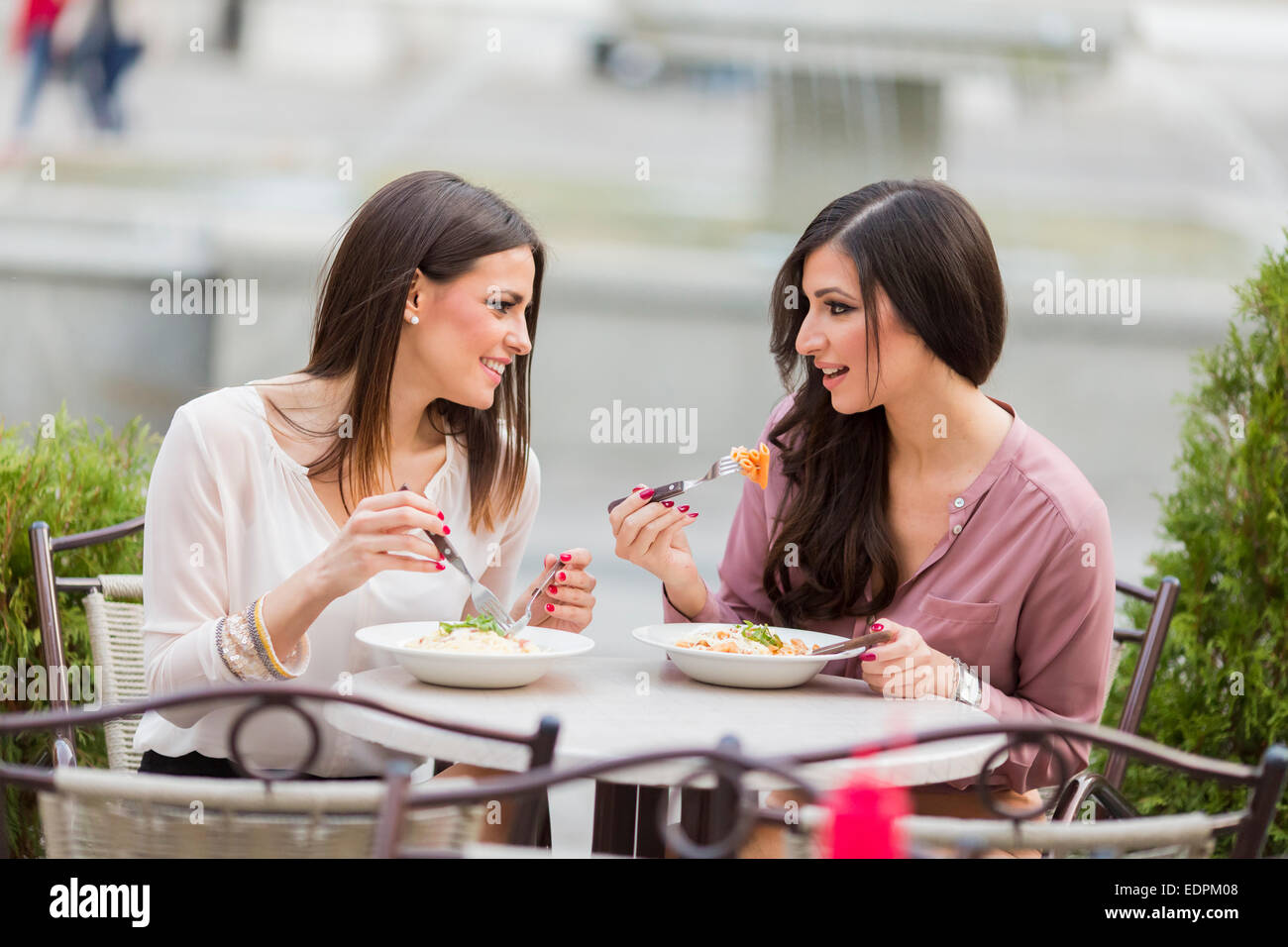 Pretty young women having lunch in the restaurant Stock Photo - Alamy