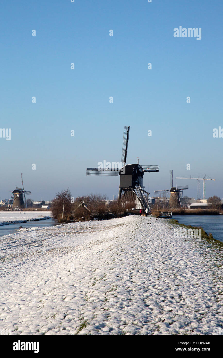 Snowy dike with Dutch windmill in Kinderdijk, Netherlands Stock Photo ...