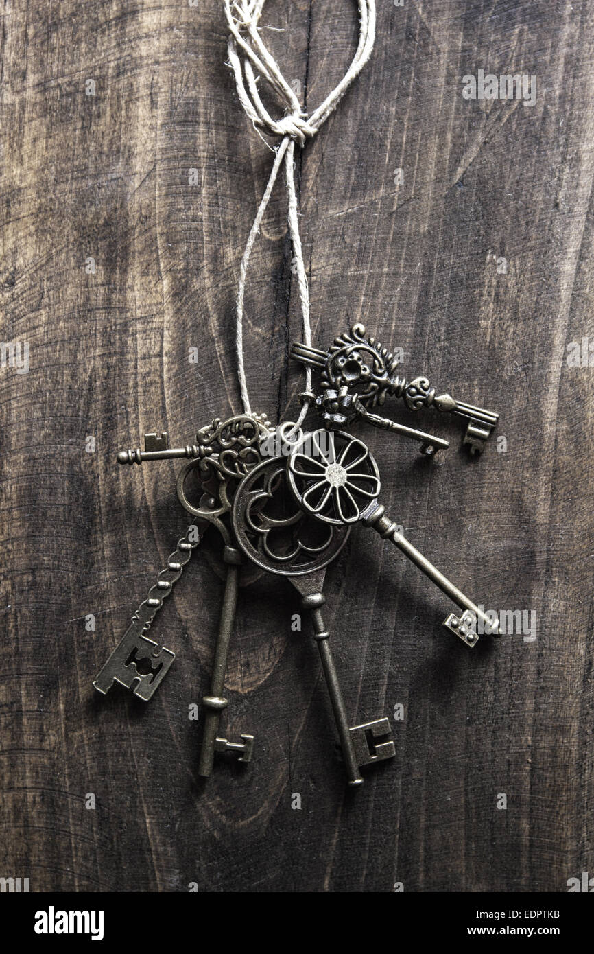 bunch of vintage keys with rope on old wooden plank Stock Photo - Alamy