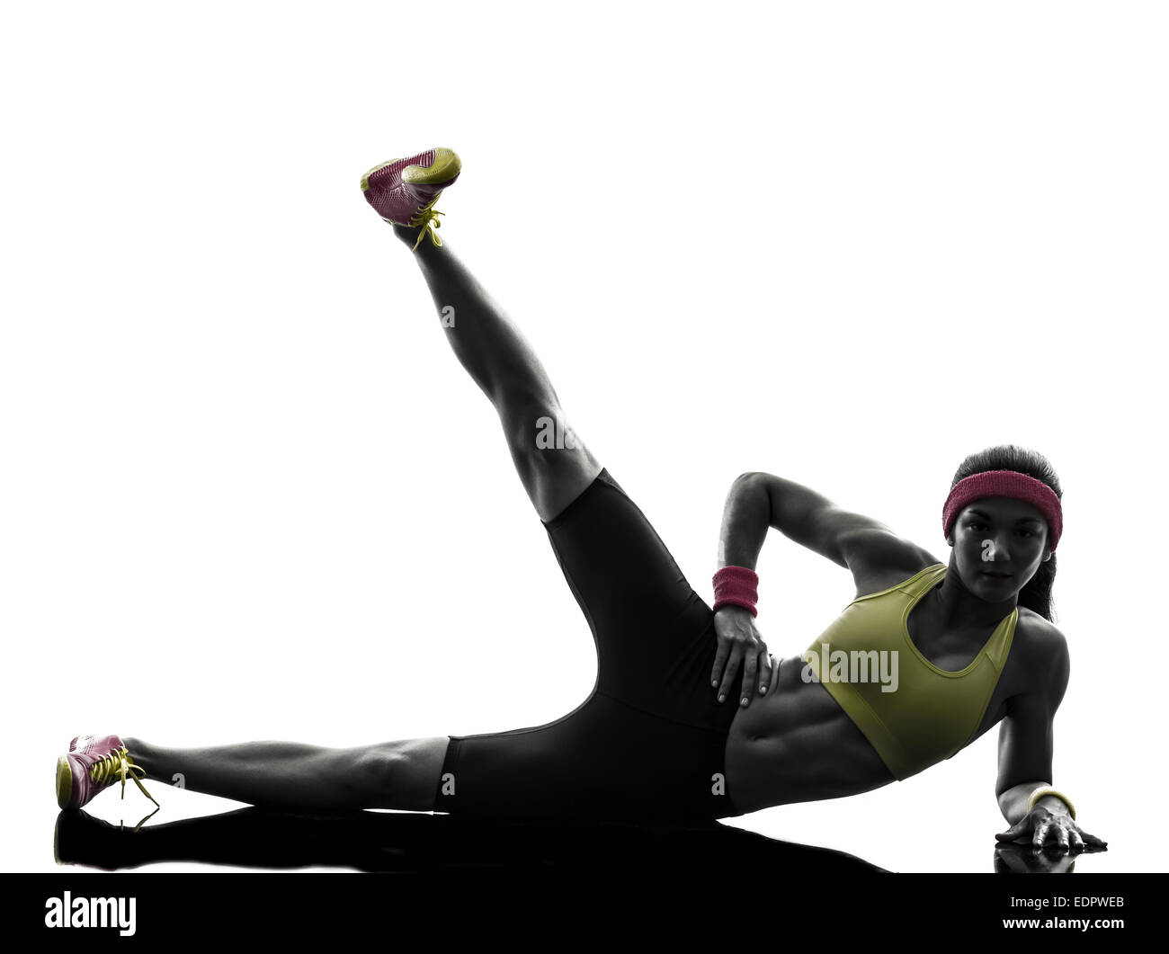one woman exercising fitness workout legs in the air lying on side in ...