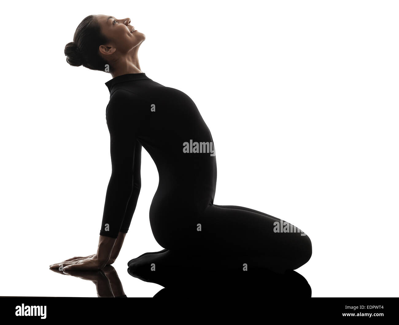 one woman contortionist practicing gymnastic yoga in silhouette on ...