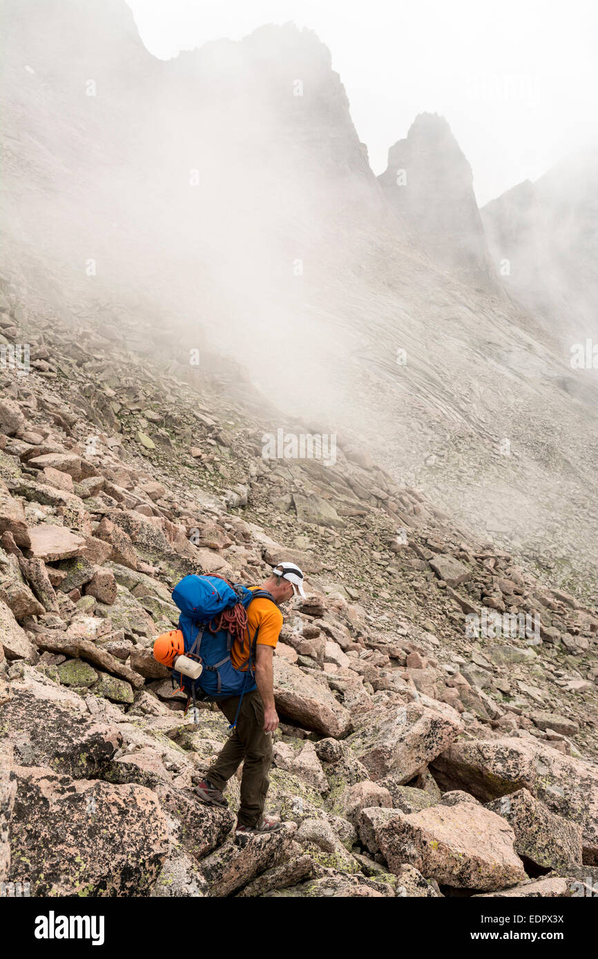 A man hiking down a rocky slope ,Rocky Mountain National Park, Estes ...