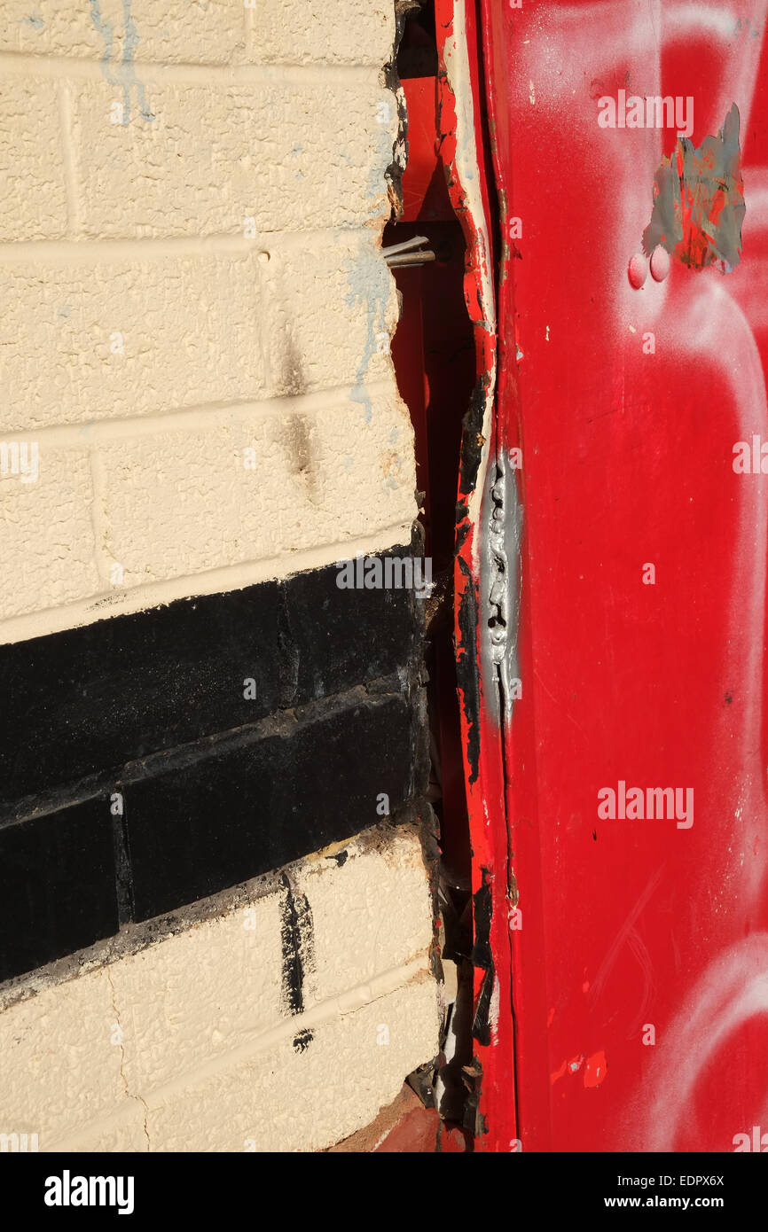 Red steel doors to a supermarket damaged by criminals trying the break ...