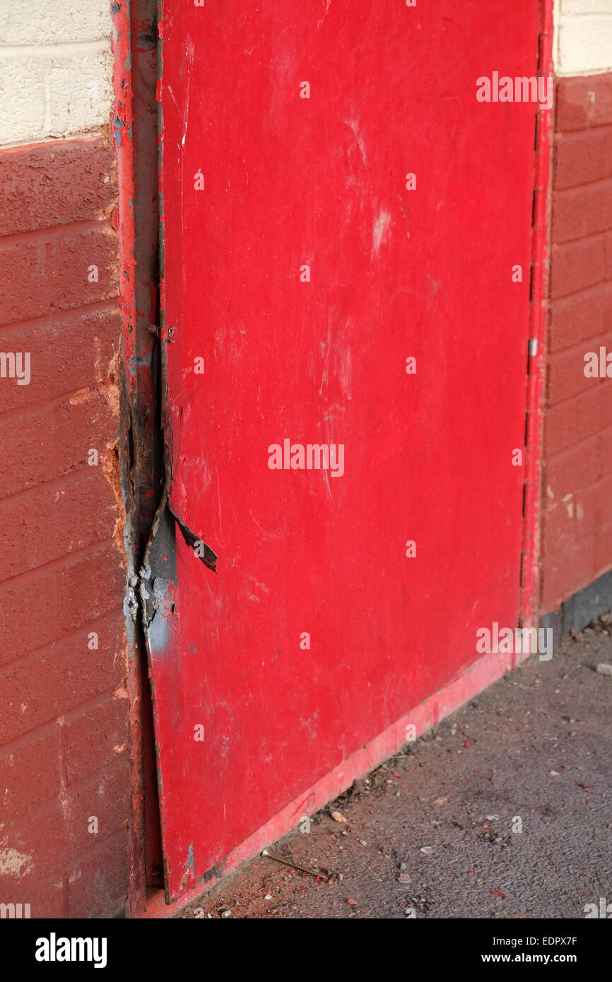 Red steel doors to a supermarket damaged by criminals trying the break ...