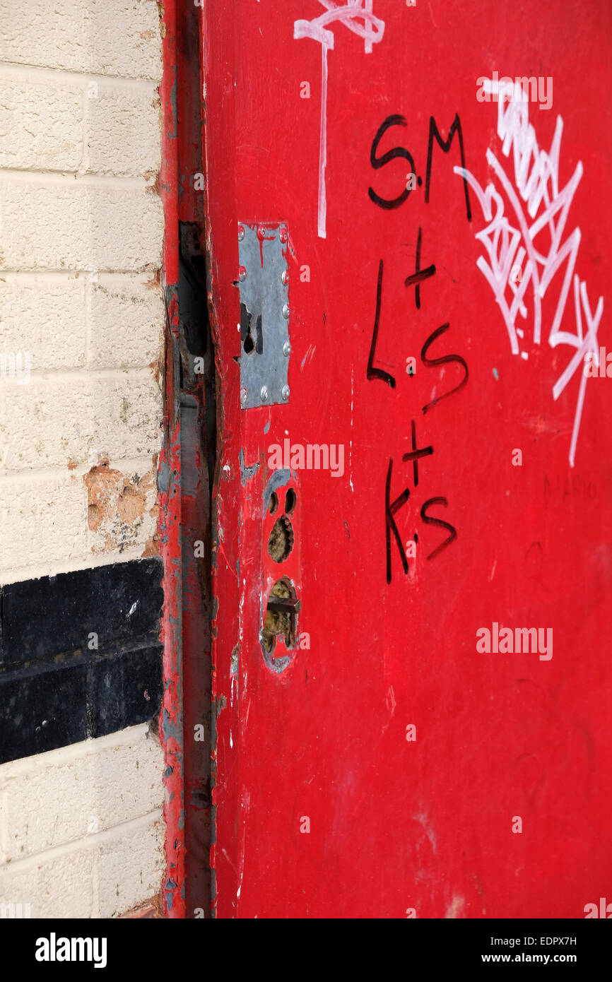Red steel doors to a supermarket damaged by criminals trying the break ...
