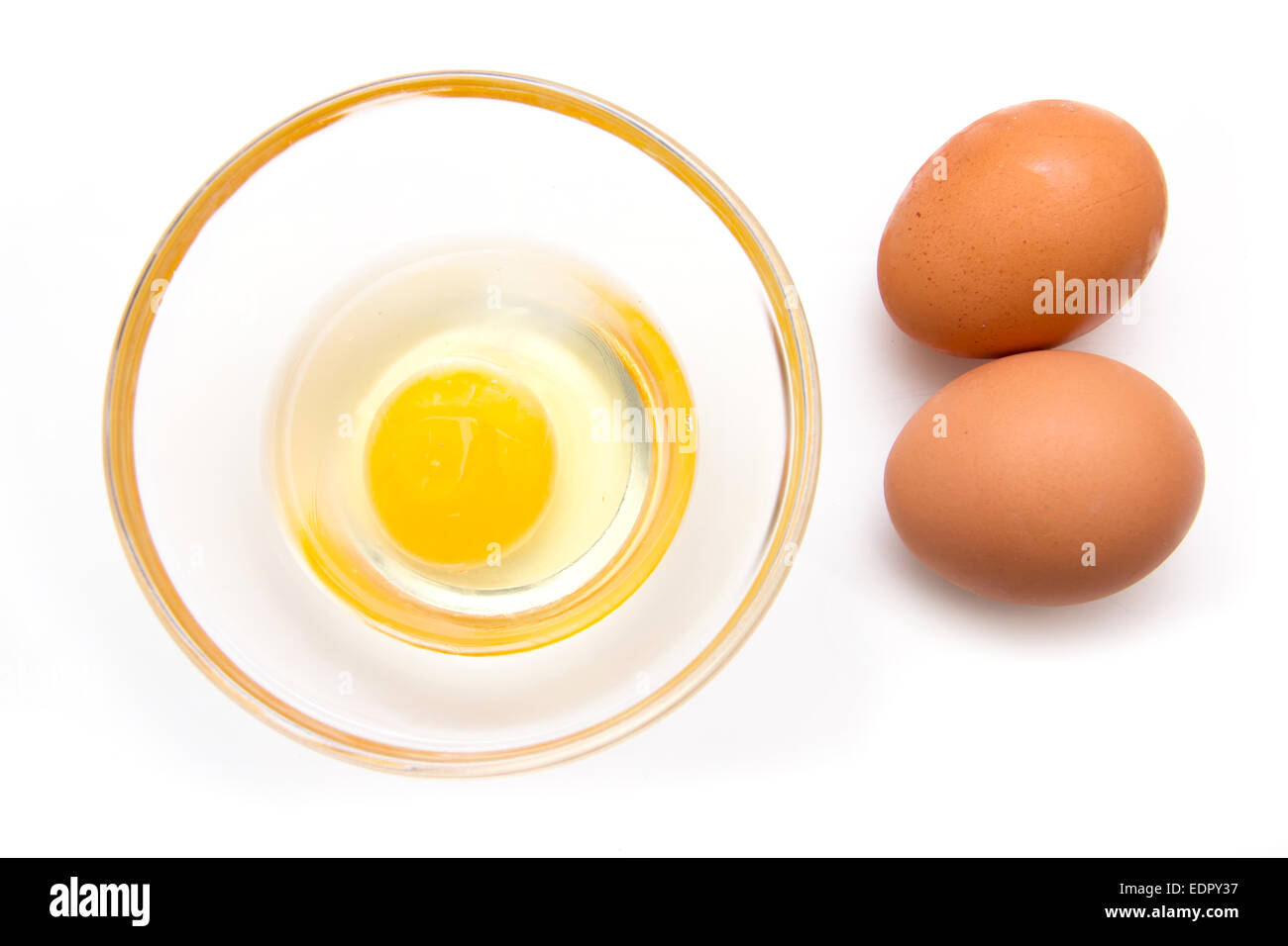Open egg on bowl on white background seen from above Stock Photo - Alamy