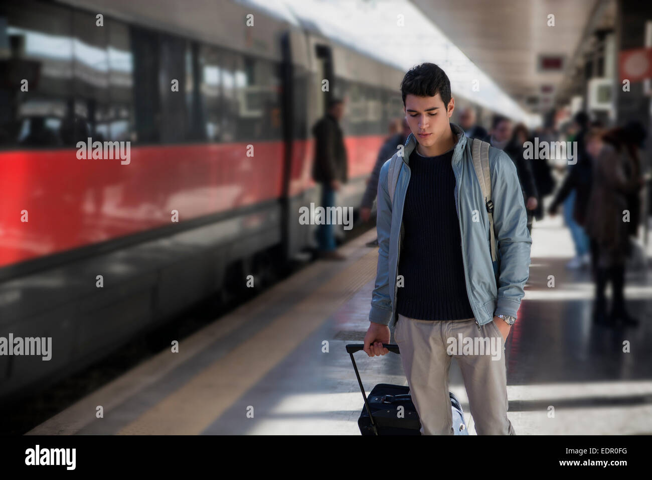 Handsome young male traveler in train station Stock Photo - Alamy