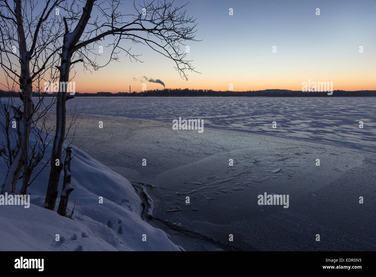 Landscape of frozen and snowy lake in the winter at morning in Tampere ...