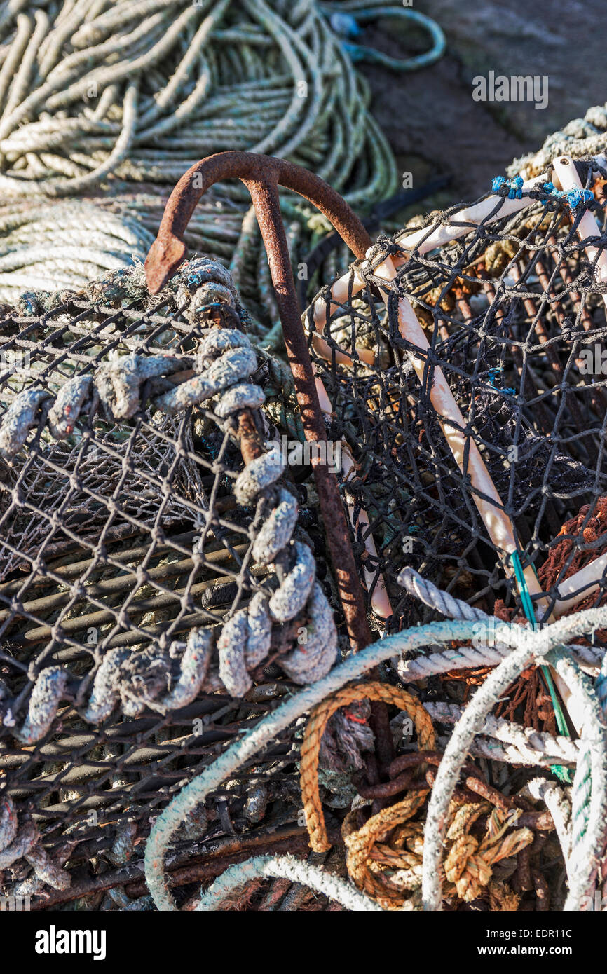 Rusty anchor amongst lobster pots at Beadnell harbour, Northumberland ...