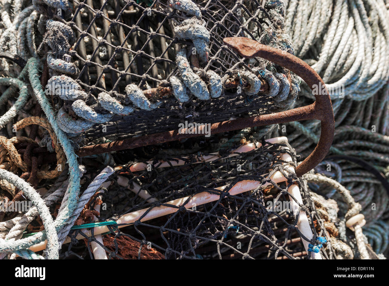 Rusty anchor amongst lobster pots at Beadnell harbour, Northumberland ...