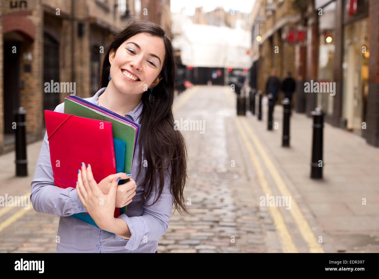 young woman holding folders Stock Photo - Alamy young woman holding folders Stock Photo - Alamy
