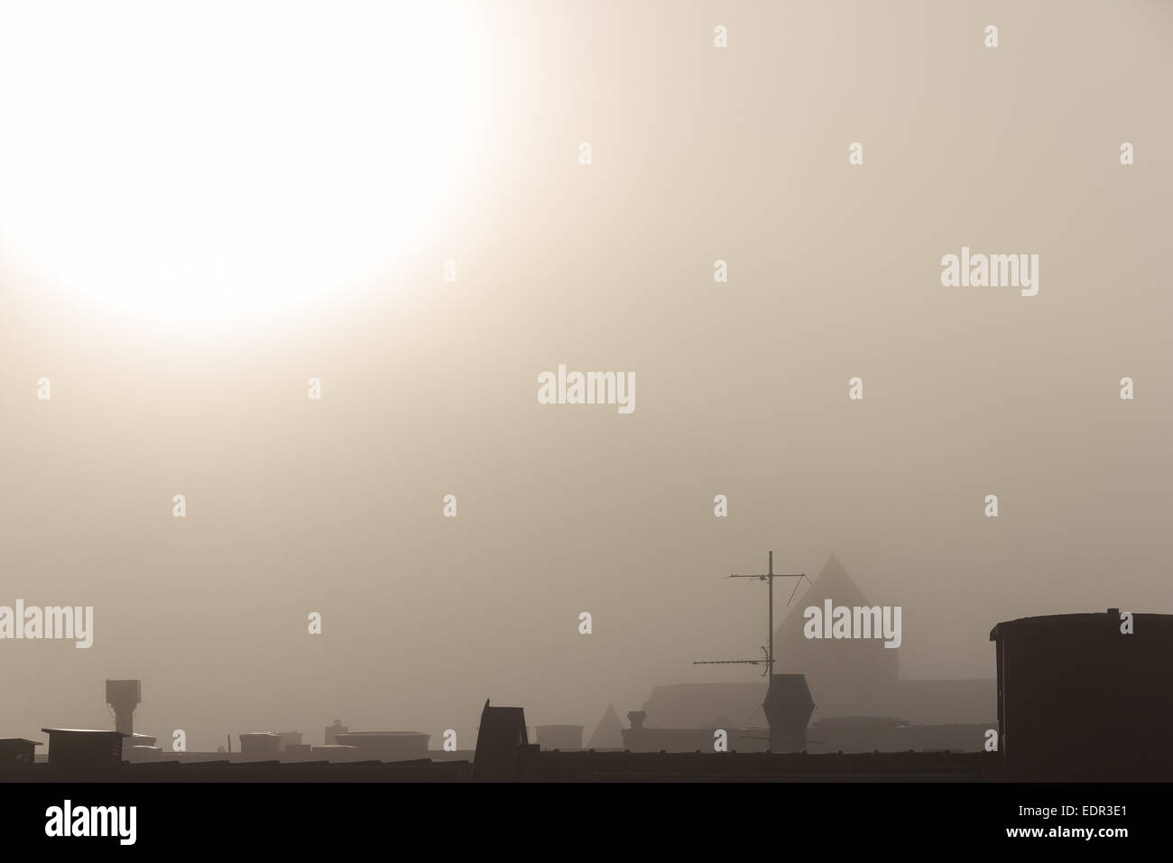 Fog over roof tops Stock Photo - Alamy