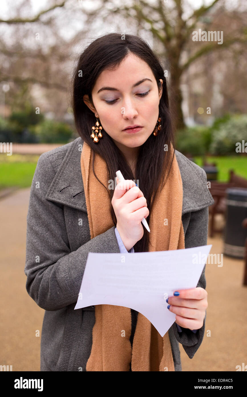 young woman reading a form Stock Photo - Alamy