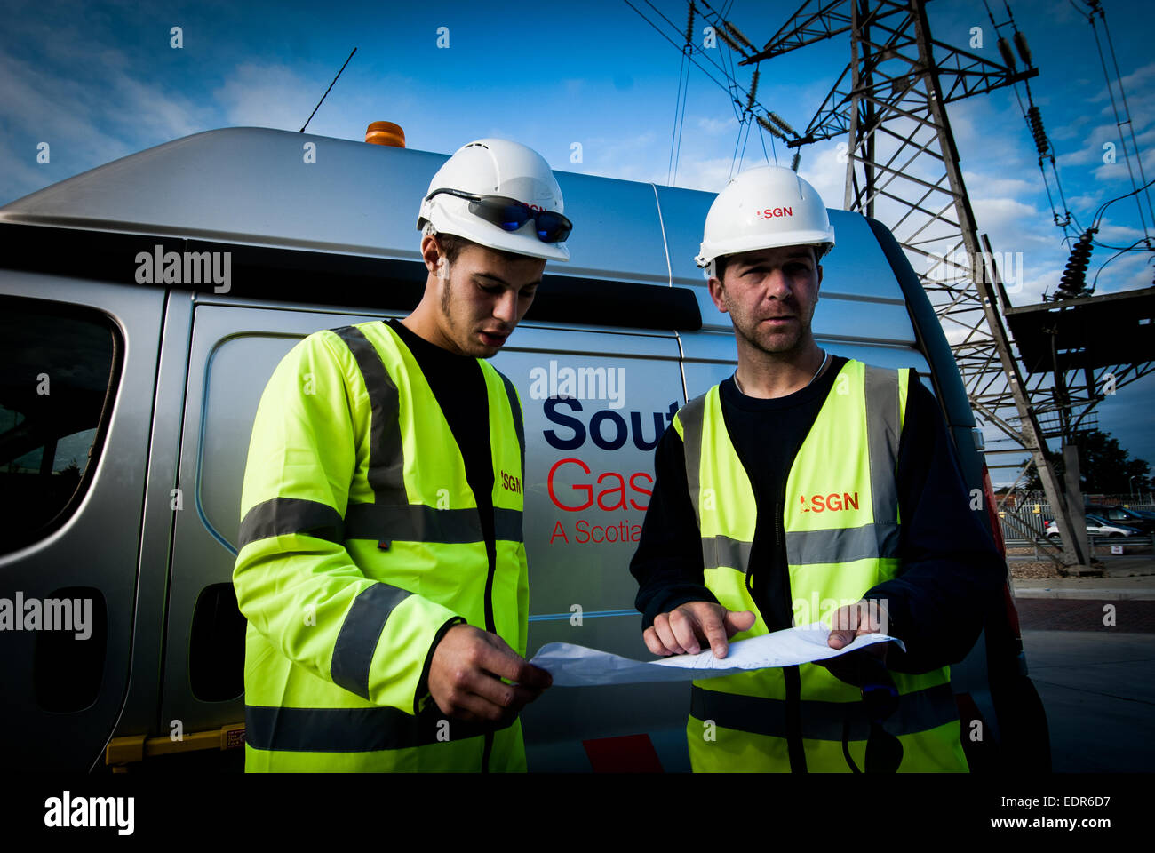 Southern Gas Network gas workers looking at plan of site in Kidlington ...
