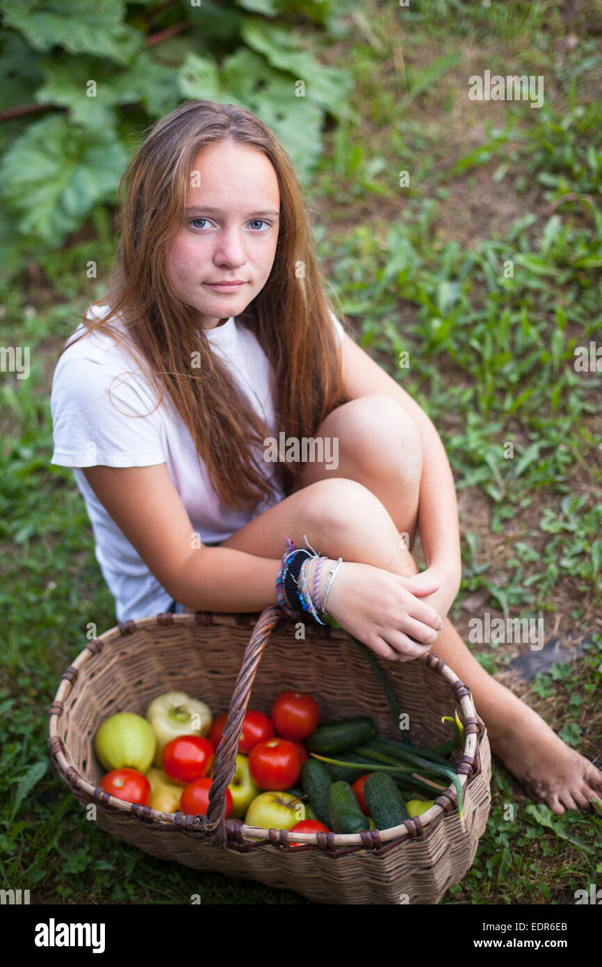 Young girl with basket of vegetables Stock Photo - Alamy