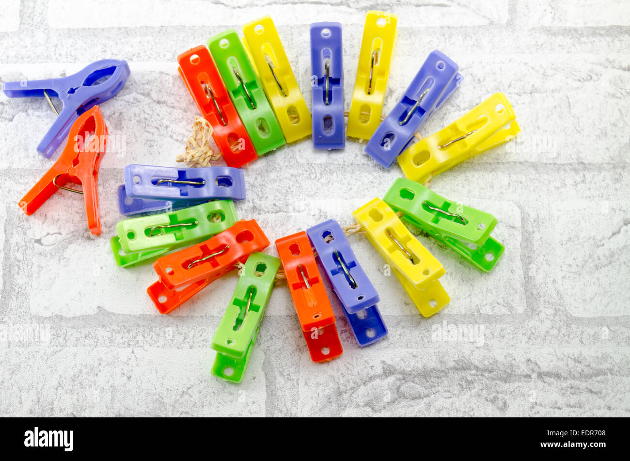 Bunch of colorful clothespins on a white wall Stock Photo - Alamy