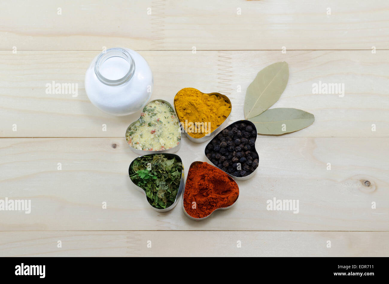 Various spices in heart shaped containers on a table Stock Photo - Alamy