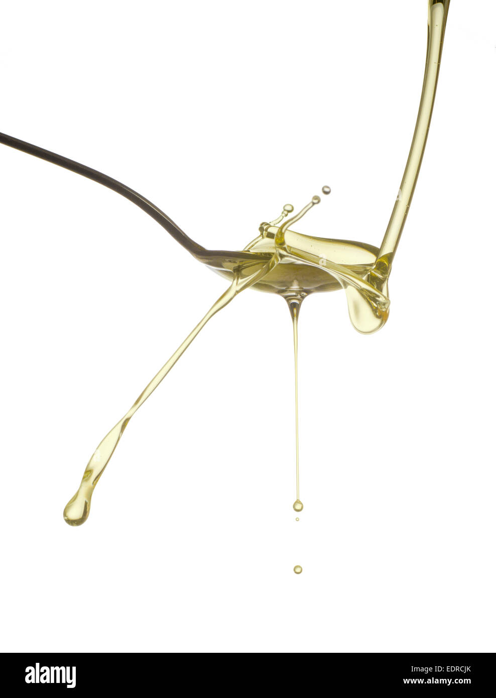 Pouring oil splash. Isolated on white background Stock Photo - Alamy